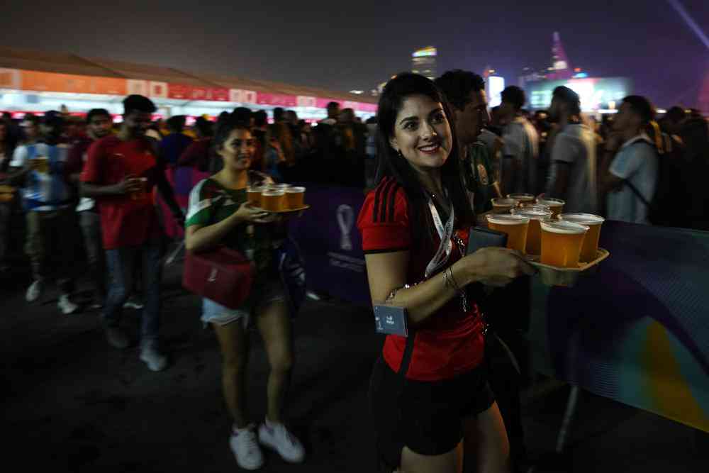 Pictures: Fans carry their beers in Doha as Qatar faces overcrowding ...